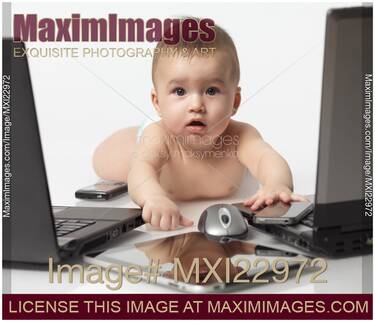 Photo of Baby amongst Computers and Electronics | Stock Image MXI22972