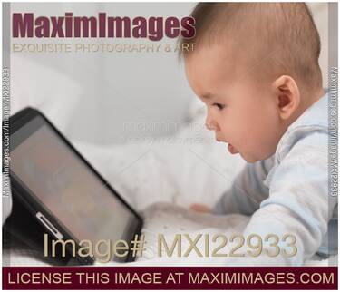 Photo of Baby Boy Watching at iPad Screen | Stock Image MXI22933