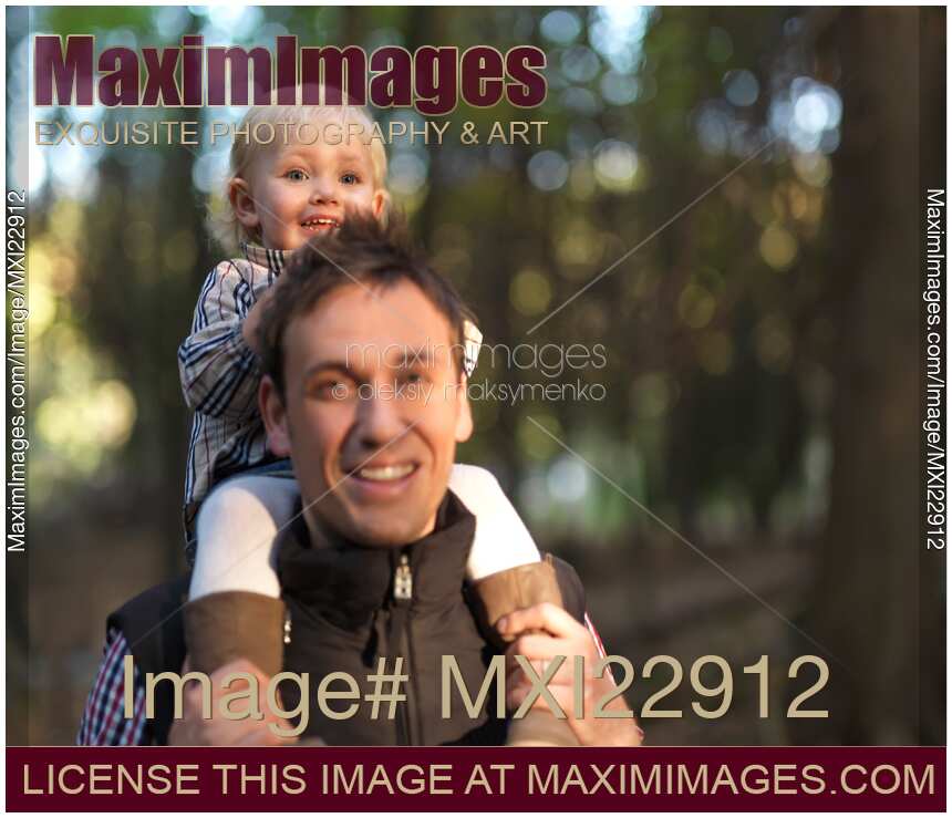 Photo of Child Riding on Her Father's Shoulders | Stock Image MXI22912