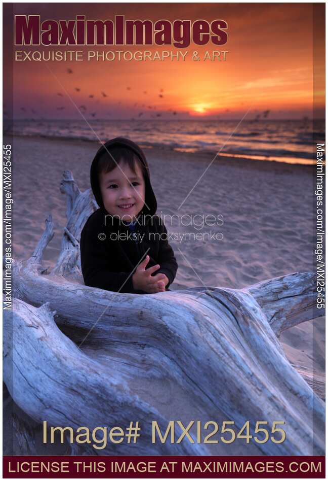 Photo of Cute happy child on a beach at sunset | Stock Image MXI25455