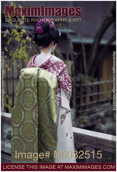 Photo of Maiko Japanese young woman apprentice Geiko in a purple kimono ...