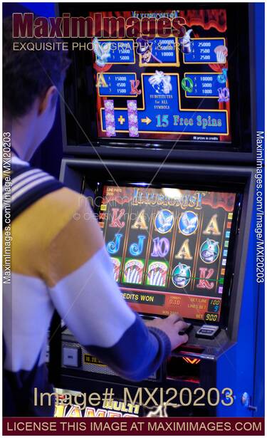 Photo of Person Playing Slot Machine in Casino | Stock Image MXI20203