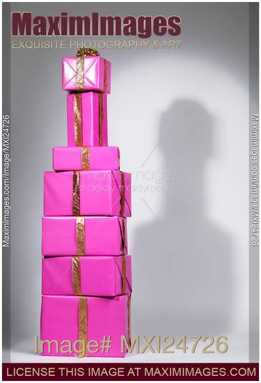 Photo of Pile of pink presents stacked in shape of alcohol bottle ...