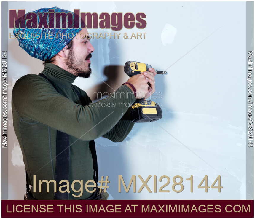 Photo of Portrait of man contractor worker hanging drywall | Stock ...