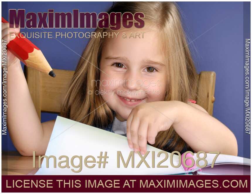 Photo of Smiling Young Girl with a Pencil | Stock Image MXI20687