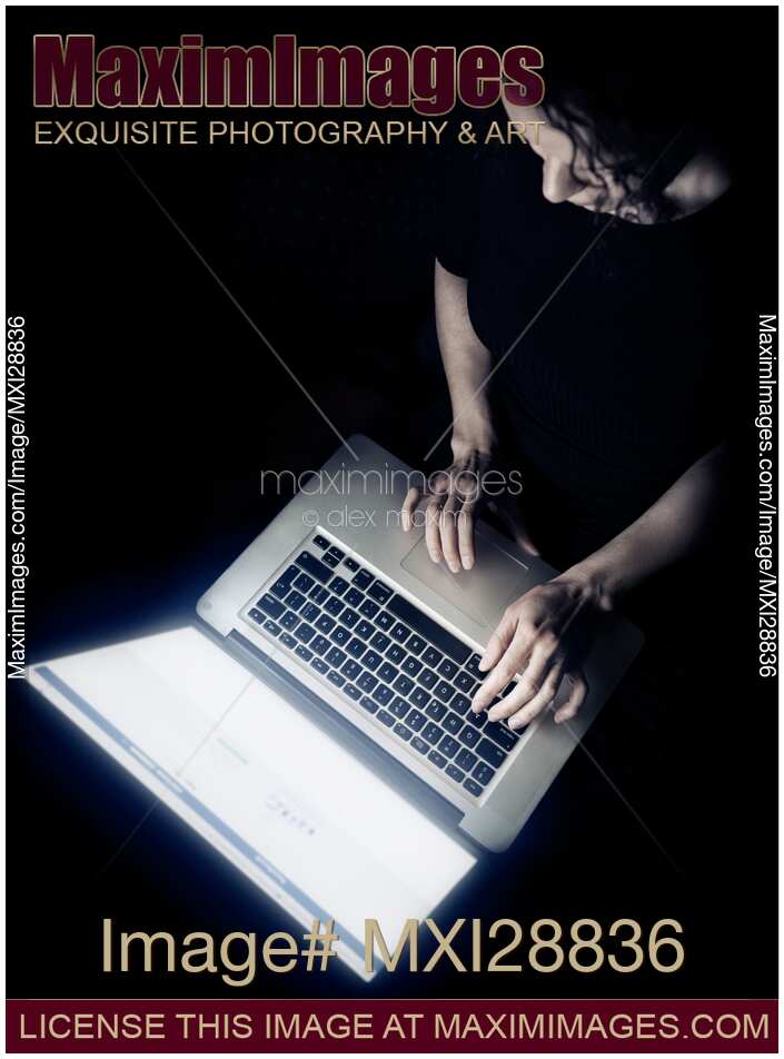 Photo of Woman face lit by the laptop screen light | Stock Image MXI28836