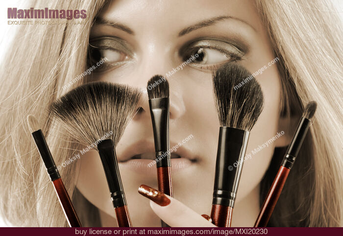 Beautiful Young Woman with Make-up Brushes. Stock Photo MXI20230