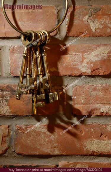 Bunch of antique keys on brick wall. Stock Photo MXI20404