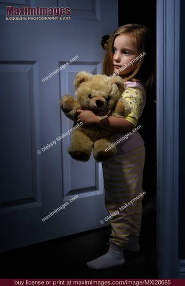 Scared Little Girl Home Alone at Night with a Teddy Bear. Stock Photo ...
