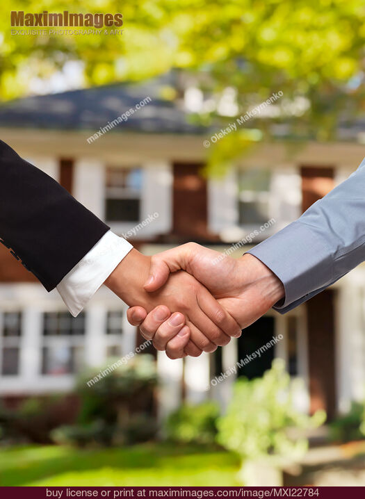 Handshake Between Man and Woman in Front of House. Stock Photo MXI22784