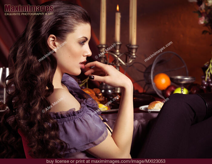 Beautiful Woman at a Festive Table. Stock Photo MXI23053