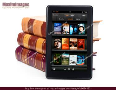 Amazon Kindle Fire leaning against books. Stock Photo MXI24122