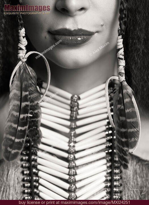 Closeup of lips of a woman wearing aboriginal necklace and feathers ...
