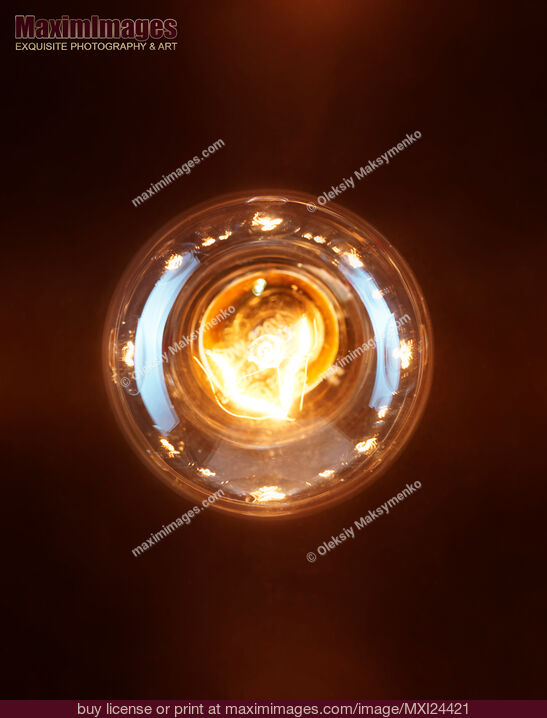 One lit incandescent light bulb. Stock Photo MXI24421