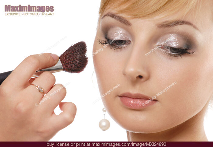 Young woman having her makeup applied. Stock Photo MXI24890
