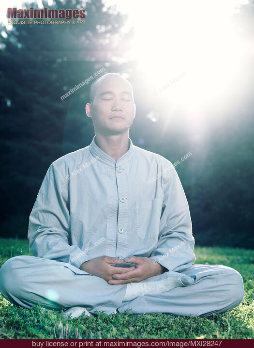 Shaolin monk meditating during sunrise. Stock Photo MXI28247