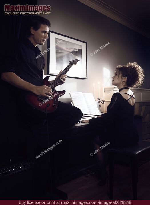 Artistic portrait of Young couple playing music. Stock Photo MXI28348