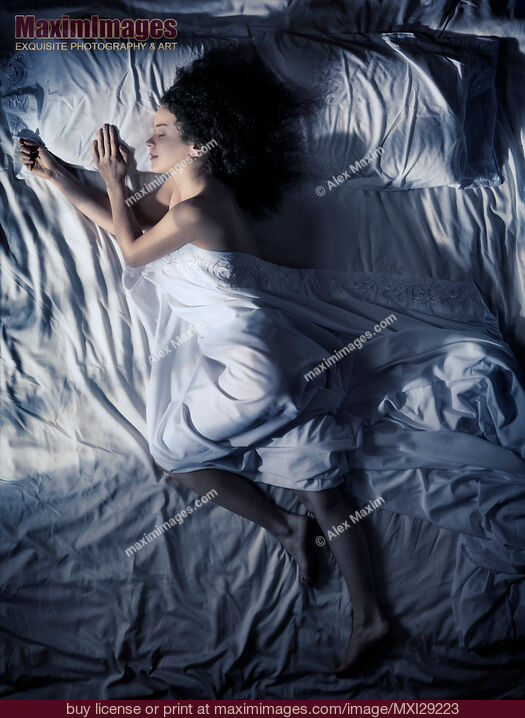 Young woman sleeping in bed at night. Stock Photo MXI29223