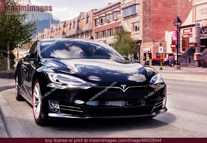 Black Tesla Model S luxury electric car parked on a city street. Stock ...