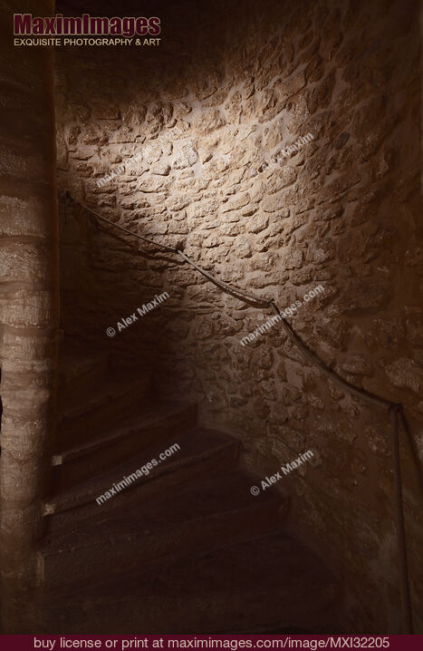 Stone steps of a spiral staircase in a dungeon of a medieval house ...