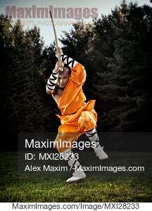 Photo of Shaolin warrior monk jumping with a staff | Stock Image MXI28233