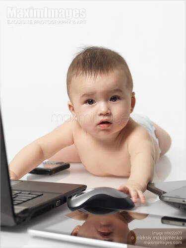 Photo of Baby amongst Computers and Electronics | Stock Image MXI22973