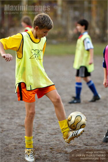 Photo of Boy practicing soccer in school | Stock Image MXI19863
