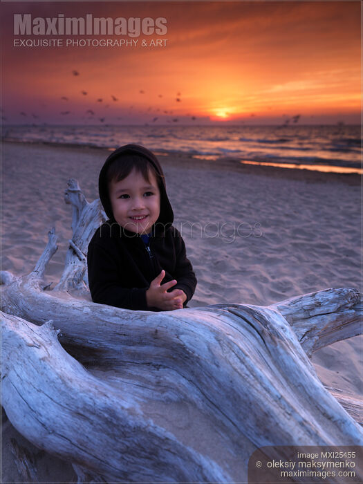 Photo of Cute happy child on a beach at sunset | Stock Image MXI25455