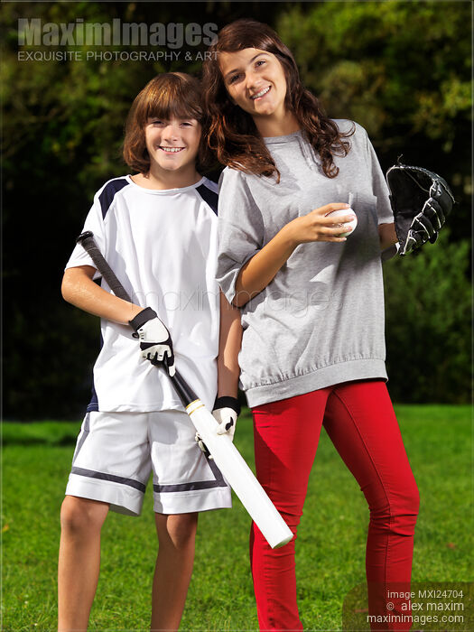 Photo of Portrait of happy Brother and sister practicing baseball ...