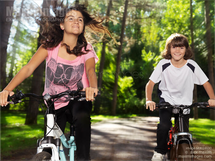 Photo of Two happy children brother and sister riding bicycles | Stock ...