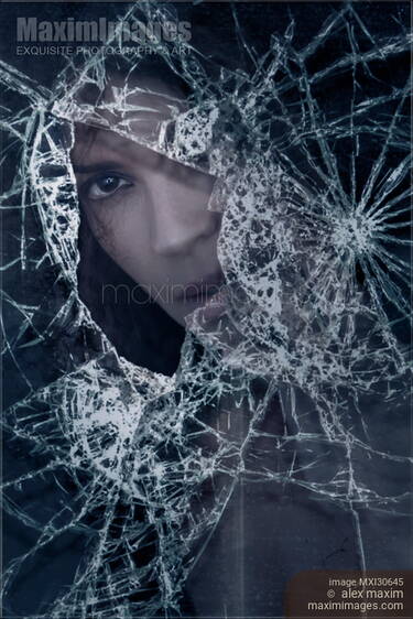 Photo of Woman face behind broken window glass with expressive look ...